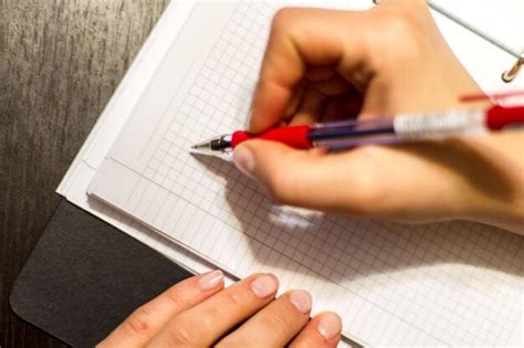 Premium Photo Close Up Of Person Working On Paper