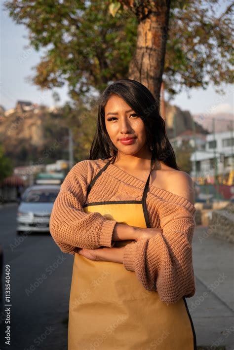 Vertical Brown Skinned Latina Working Woman With Her Arms Crossed On