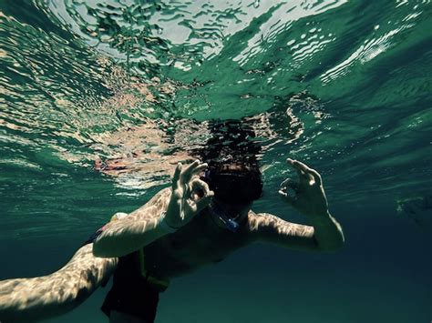 Premium Photo Shirtless Man Gesturing While Swimming In Sea