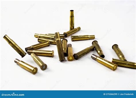 Pile Of Gold Empty Casings Or Shells From Gun Shooting Laying On White