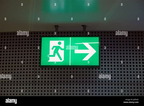 Emergency Exit Sign Glowing In The Dark Stock Photo Alamy