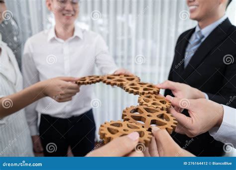 Group Of People Making Chain Of Gears Into Collective Form For Harmony Symbol Stock Photo