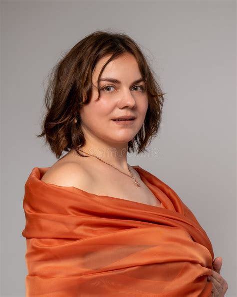 Portrait Of A Beautiful Dark Haired Girl With An Orange Shawl On Her