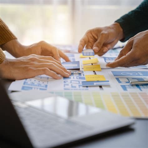 Premium Photo Ui Designer Brainstorming About Mobile App Interface Wireframe Design With