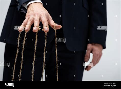 Partial View Of Puppeteer In Suit With Strings On Fingers Isolated On Grey Stock Photo Alamy