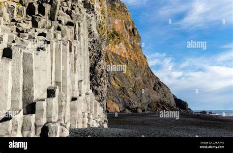 Gardar Basalt Columns On Reynisfjara Black Sand Beach Iceland A Rocky Cliff With A Gray And