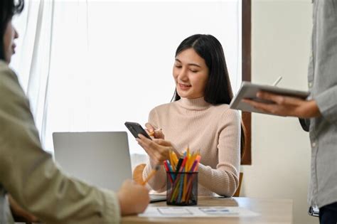 Premium Photo Professional Asian Female Developers Working With Her Colleagues On A New Mobile