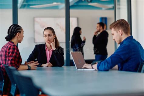 A Team Of Successful Programmers Sits In A Startup Office Strategizing New Business Projects