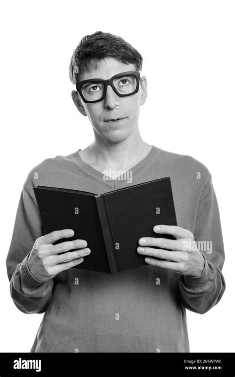 Portrait Of Nerd Man Thinking While Holding Book Stock Photo Alamy