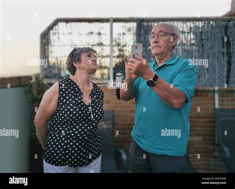 Two Elderly People Discovering Various Aspects Of Electronic Devices