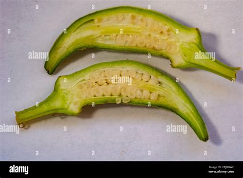 Two Halves Of An Okra With Thier Cross Section Turning Upwards Is On A