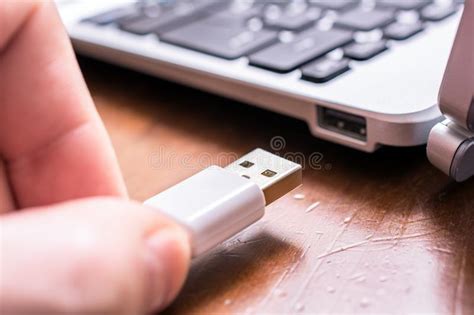 Male Hand Connecting A White USB Cable To The USB Port Of A Small Keyboard Stock Photo Image