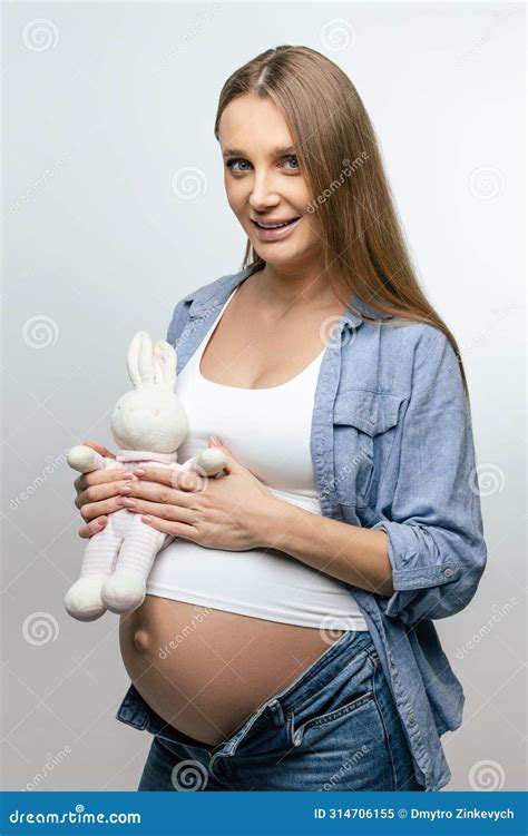 Cute Pregnant Woman Holding A Toy Bunny In Her Hands Stock Image