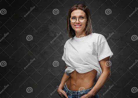 Woman Smiles In Eyewear Lifting Her Crop Top To Spotlight A Sculpted
