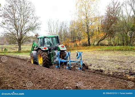 John Deere Green Tractor Plowing In Autumn Farmer Plowing Stubble On