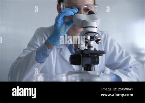 Woman Scientist Wearing Lab Coat White Protective Gloves And Glasses