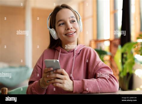 Modern Teens Lifestyle Dreamy Teen Girl Using Cellphone And Wearing