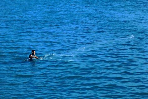 Premium Photo Man Holding Fishing Net In Sea