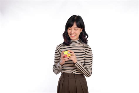 Asian Woman Holding A Rubik Cube Standing On White Background Solving Cubic Problems Problem