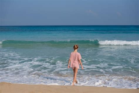 Premium Photo Rear View Of Woman Standing At Beach