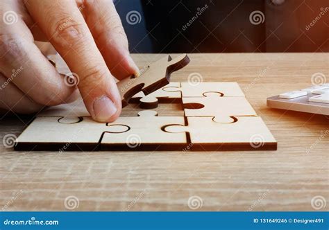 Business Success And Problem Solving Man Holds Piece Of Puzzle Stock