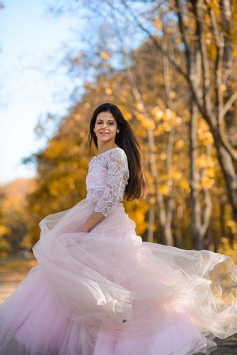 Girl With Long Hair In A Beautiful Light Puffy Dress Is Spinning On The