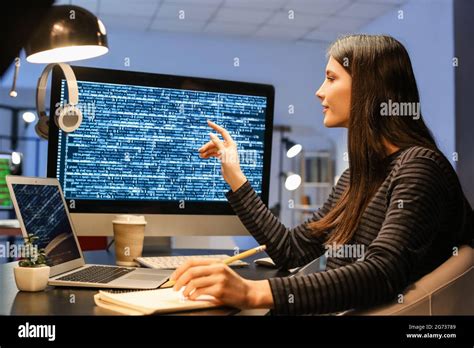 Female Programmer Working With Laptop In Office At Night Stock Photo Alamy