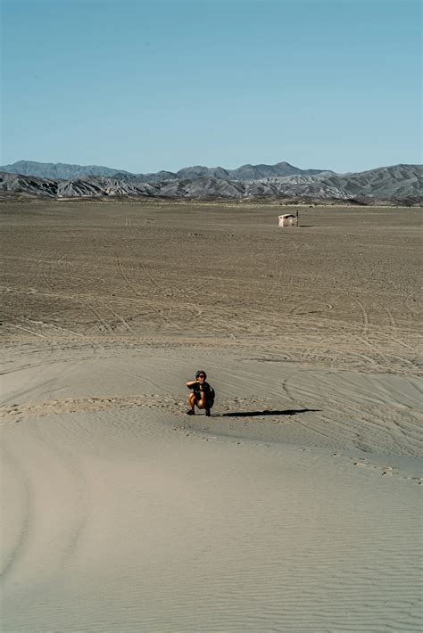 Gray Grass Field Leading To Mountains Under Gray Heavy Clouds · Free