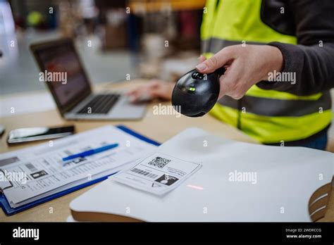 Female Warehouse Worker Holding Scanner Scanning The Barcodes On
