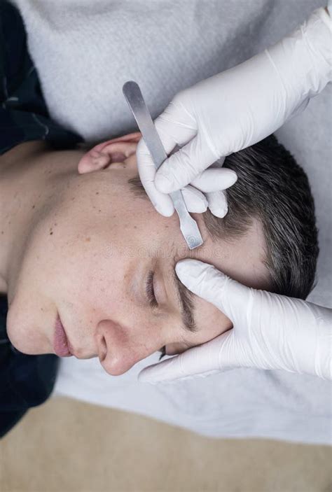 A Dermatologist Takes A Skin Scraping And Tests For Demodicosis And