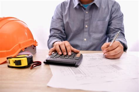 Premium Photo Midsection Of Engineer Drawing Blueprint In Office