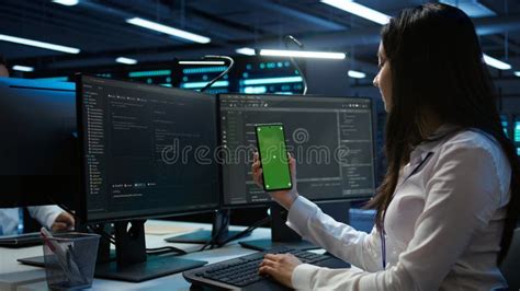Worker Overseeing Data Center Using Green Screen Mobile Phone Stock