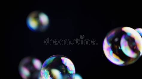 Colorful Soap Bubbles Fly In An Empty Space On Isolated Black