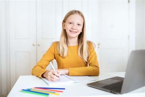 Premium Photo A Teen Girl With Long Blonde Hair Smiles While Sitting