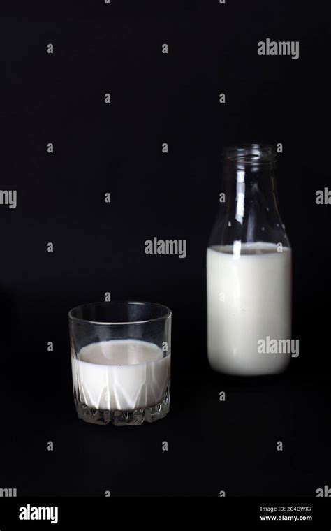 A Bottle And A Flass Of Milk Isolated On Black Background Image Contains Copy Space Vertical