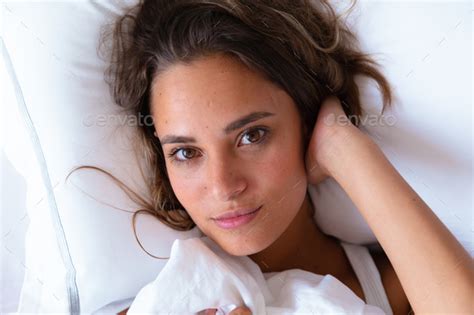 Close Up Portrait Of Caucasian Beautiful Young Woman Lying On The Bed