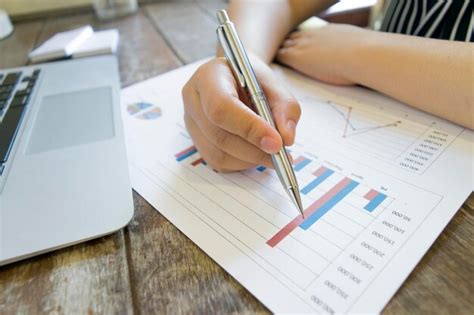 Premium Photo Midsection Of Woman Analyzing Graphs On Table