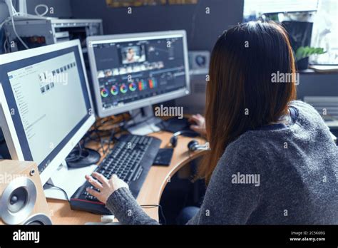 Brunette Is Working In Video Processing Program The Girl Looks Carefully At The Monitor Of Her