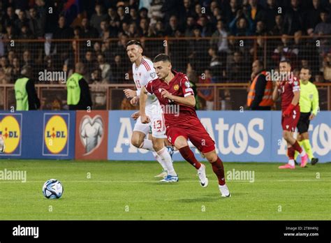 A Young Athlete Sprints After A Soccer Ball While Other Players Are