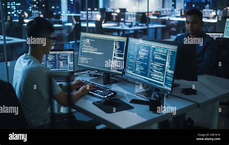 Night Office Young Japanese Man In Working On Desktop Computer Diverse Multi Ethnic Team Of