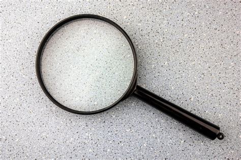 Premium Photo Black Magnifying Glass On A Blue Table Glass For