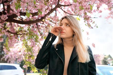 Premium Photo Woman Suffering From Seasonal Pollen Allergy Near Blossoming Tree Outdoors