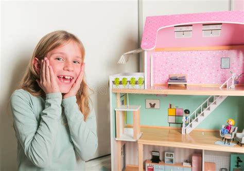 Chica Feliz Juega Con Casa De Muñecas Y Muñecas Niño Feliz Imagen de archivo Imagen de dolar