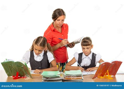 The Teacher Checks How Students Cope With The Assignment And Notes The