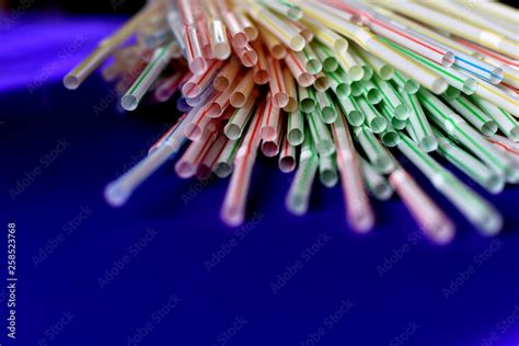 Bunch Of Single Use Disposable Colorful Plastic Straws On The Blue