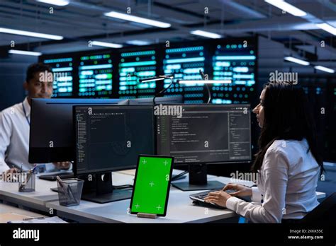 Team Of Programmers In Data Center Using Isolated Screen Tablet To