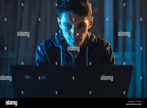 cybercriminal hacker typing program code while stealing access