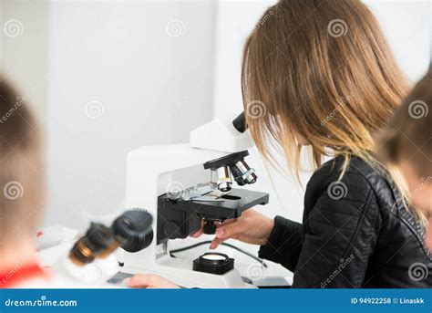 Girl At The Lab Looking Through Microscope Stock Photography CartoonDealer