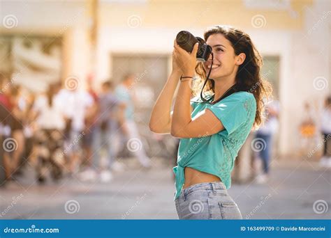 Girl Tourist Or Professional Photographer Who Shoots In A Typical