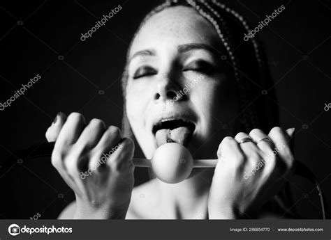 BDSM Outfit For Adult Sex Games A Babe Woman Licks Gag Ball Black And White Stock Photo